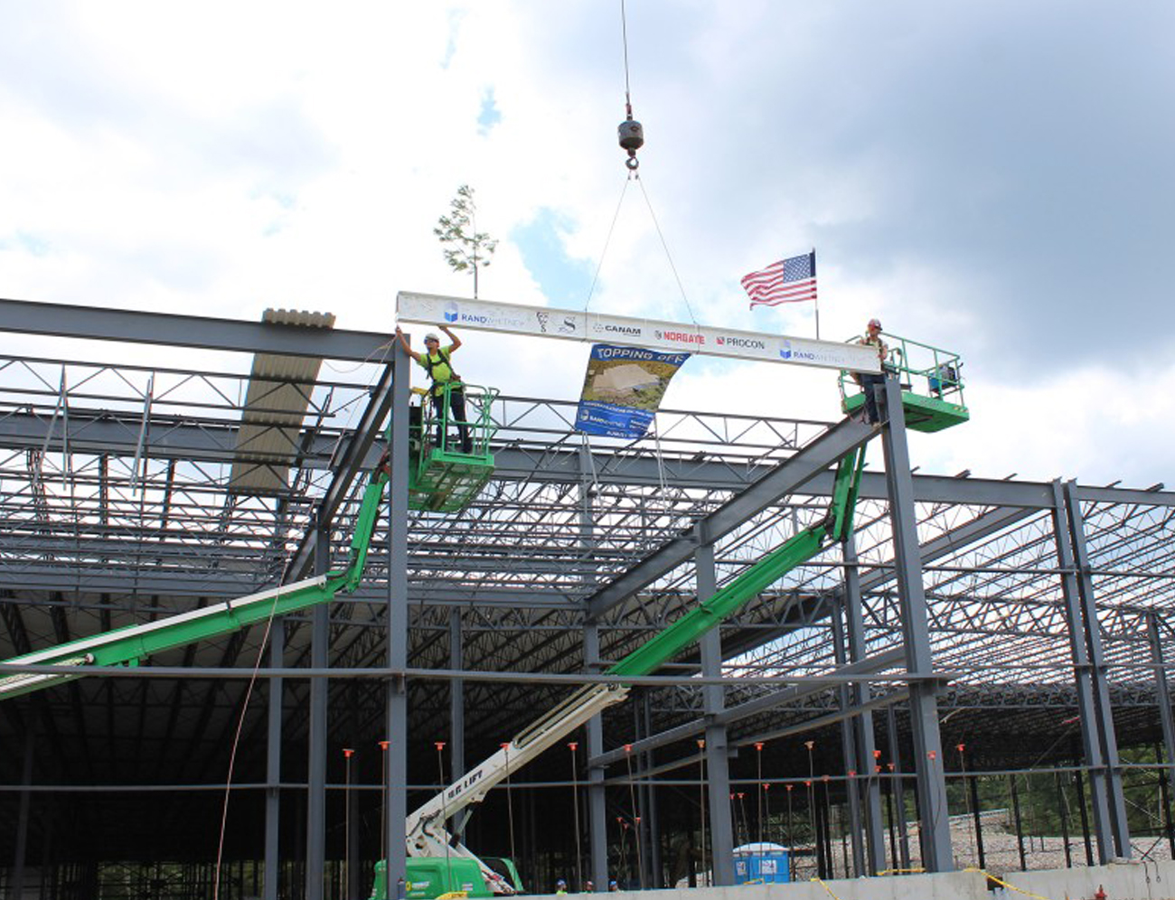 Rand-Whitney signs and raises final beam on its latest facility ...